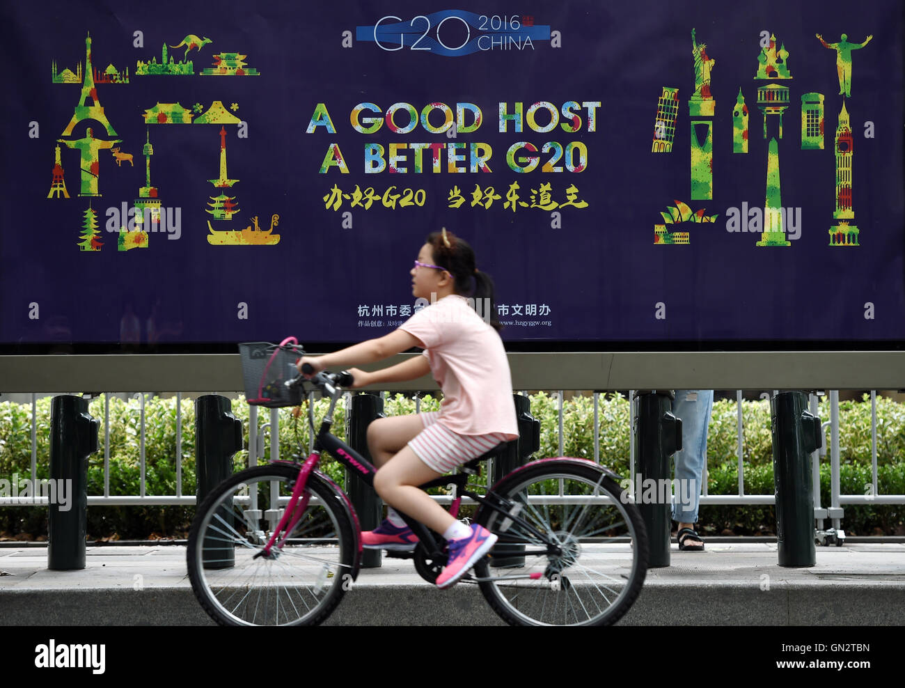 Hangzhou, China's Zhejiang Province. 27th Aug, 2016. A girl rides past ...