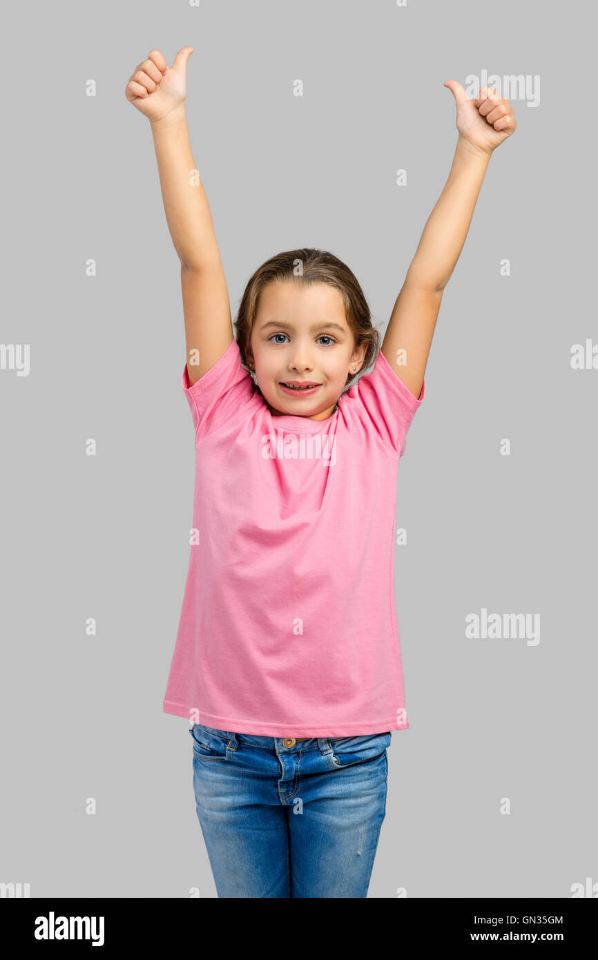 Studio portrait of a happy little girl with arms raised on air Stock ...