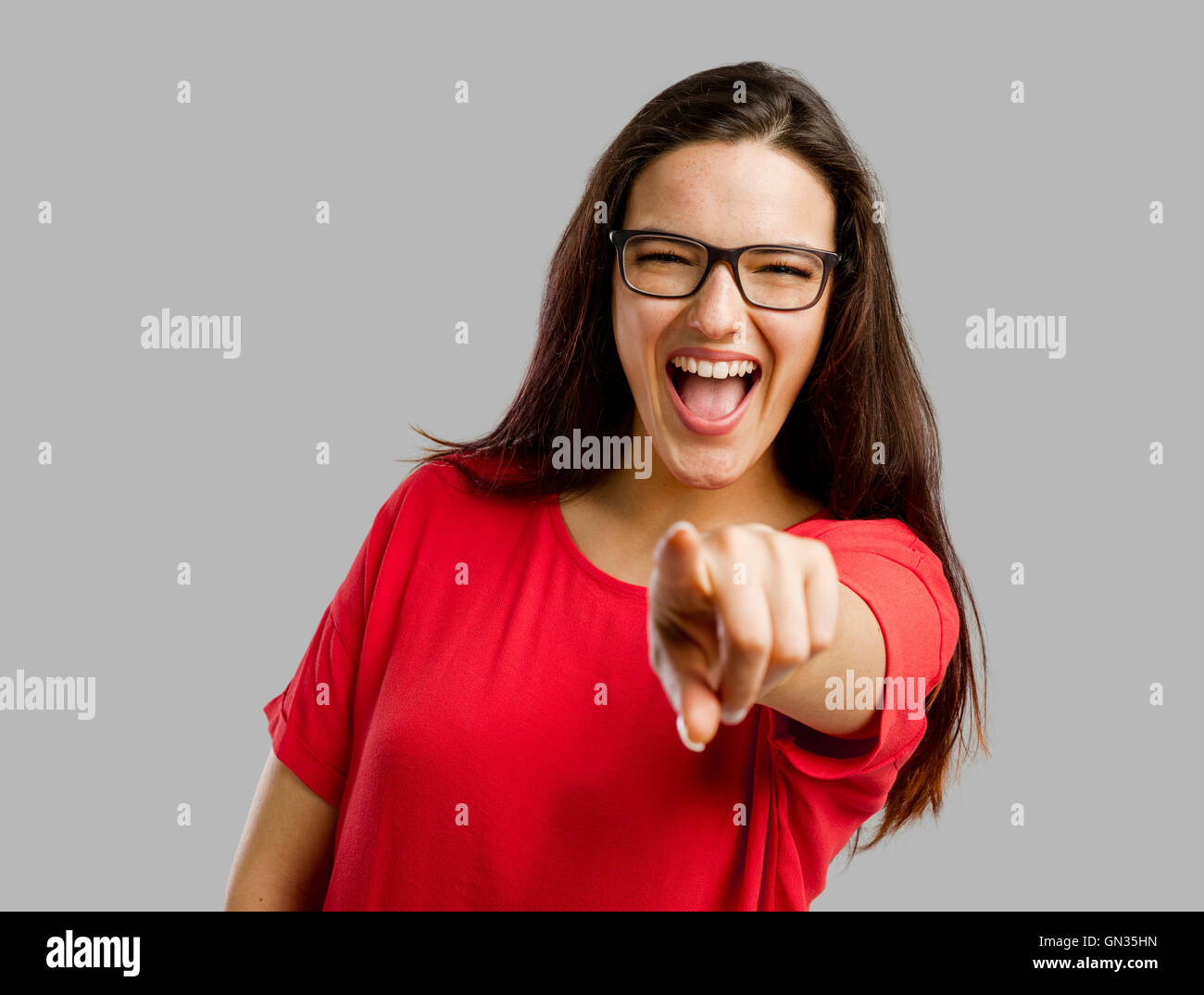 Happy woman smiling and pointing to the camera Stock Photo - Alamy