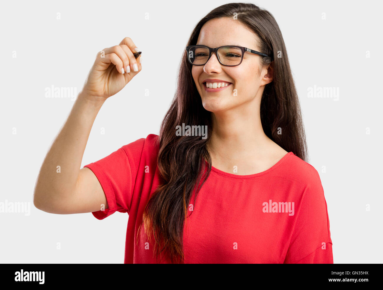 Lovely woman writing something on a glass board, isolated over white ...