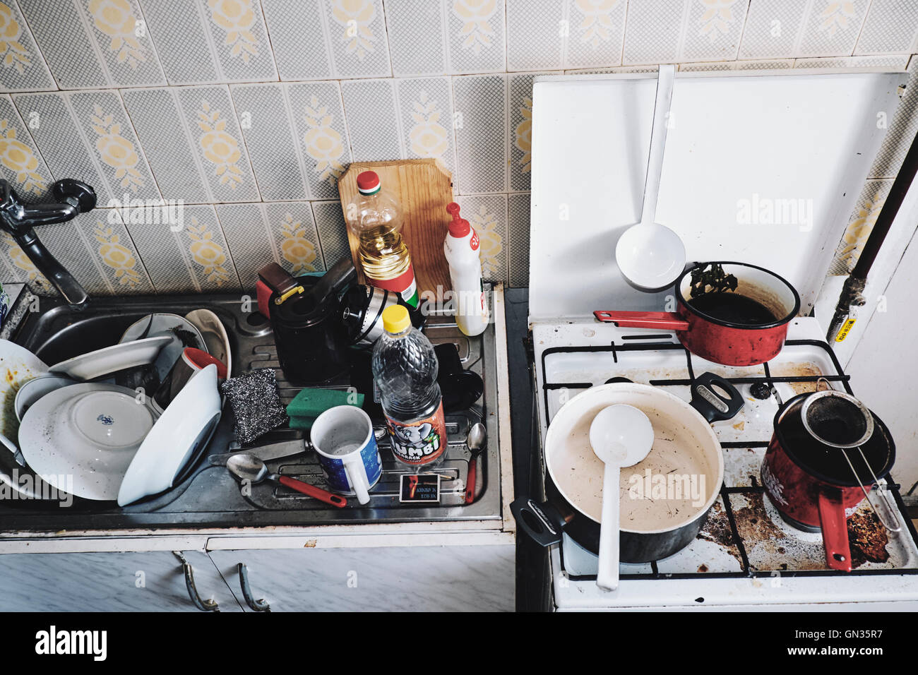 Cluttered Kitchen with Dirty Dishes and Stovetop Stock Photo - Alamy