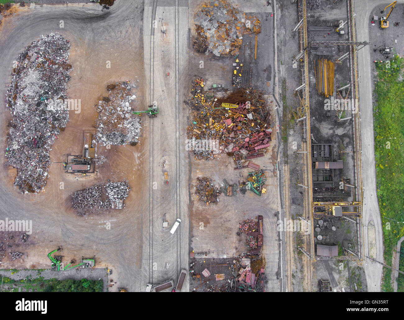 Iron raw materials recycling pile, work machines. Metal waste junkyard ...