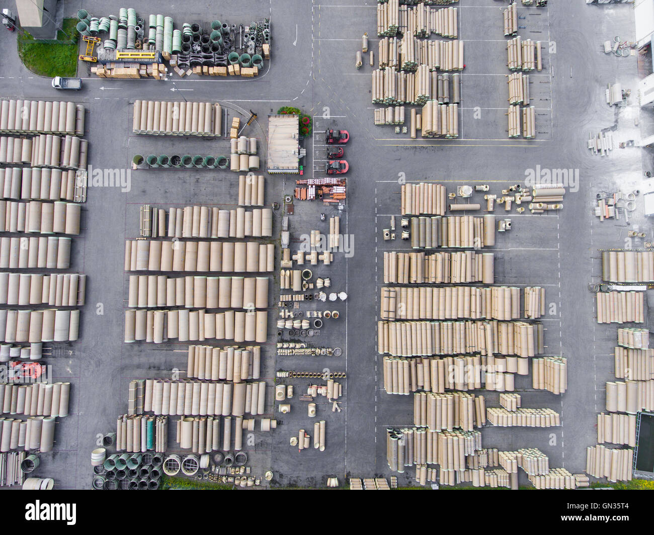 Industrial concrete drainage pipes stacked for construction. New tubes ...