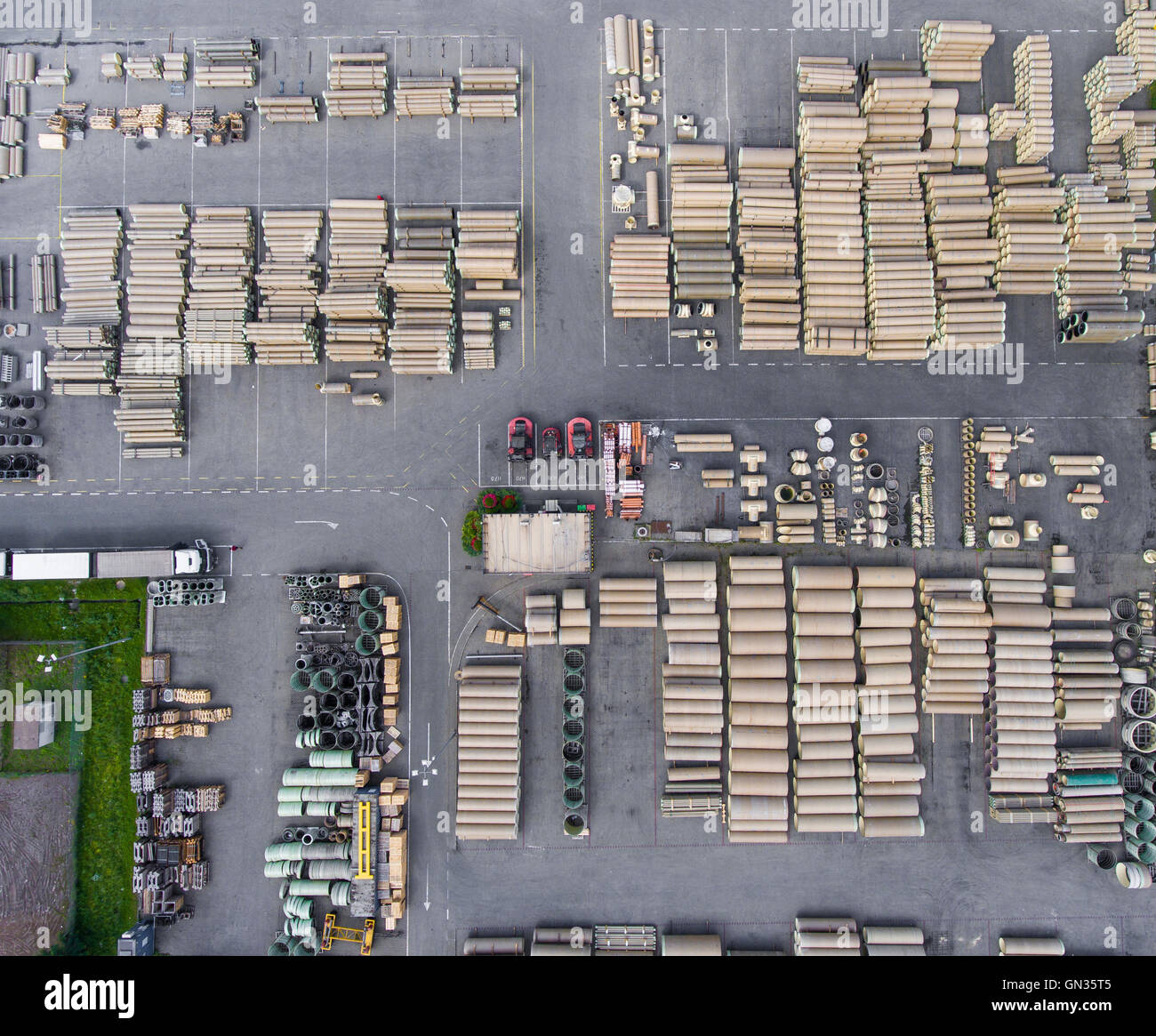 Industrial concrete drainage pipes stacked for construction. New tubes ...