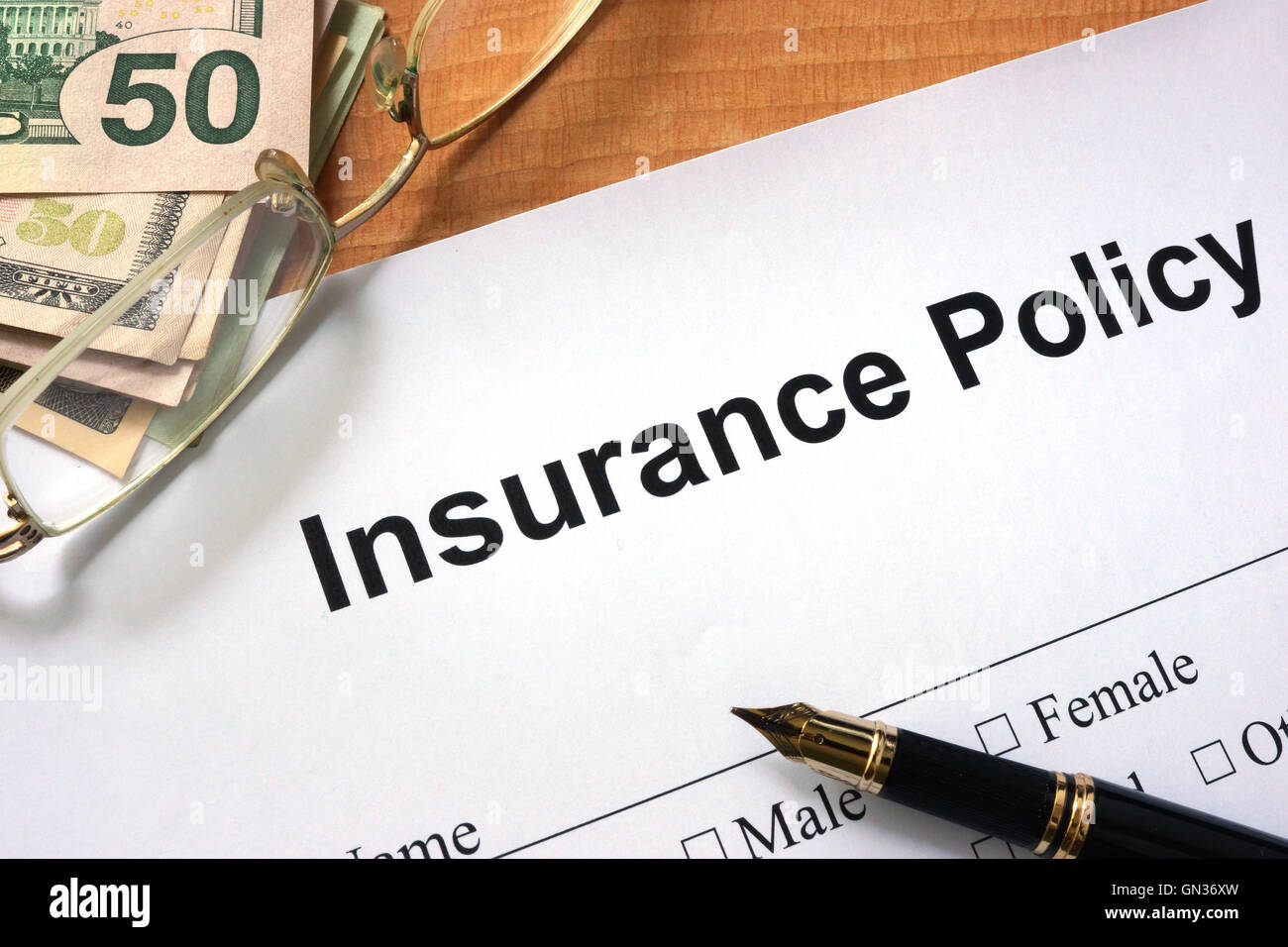Paper with words insurance policy form and money Stock Photo - Alamy