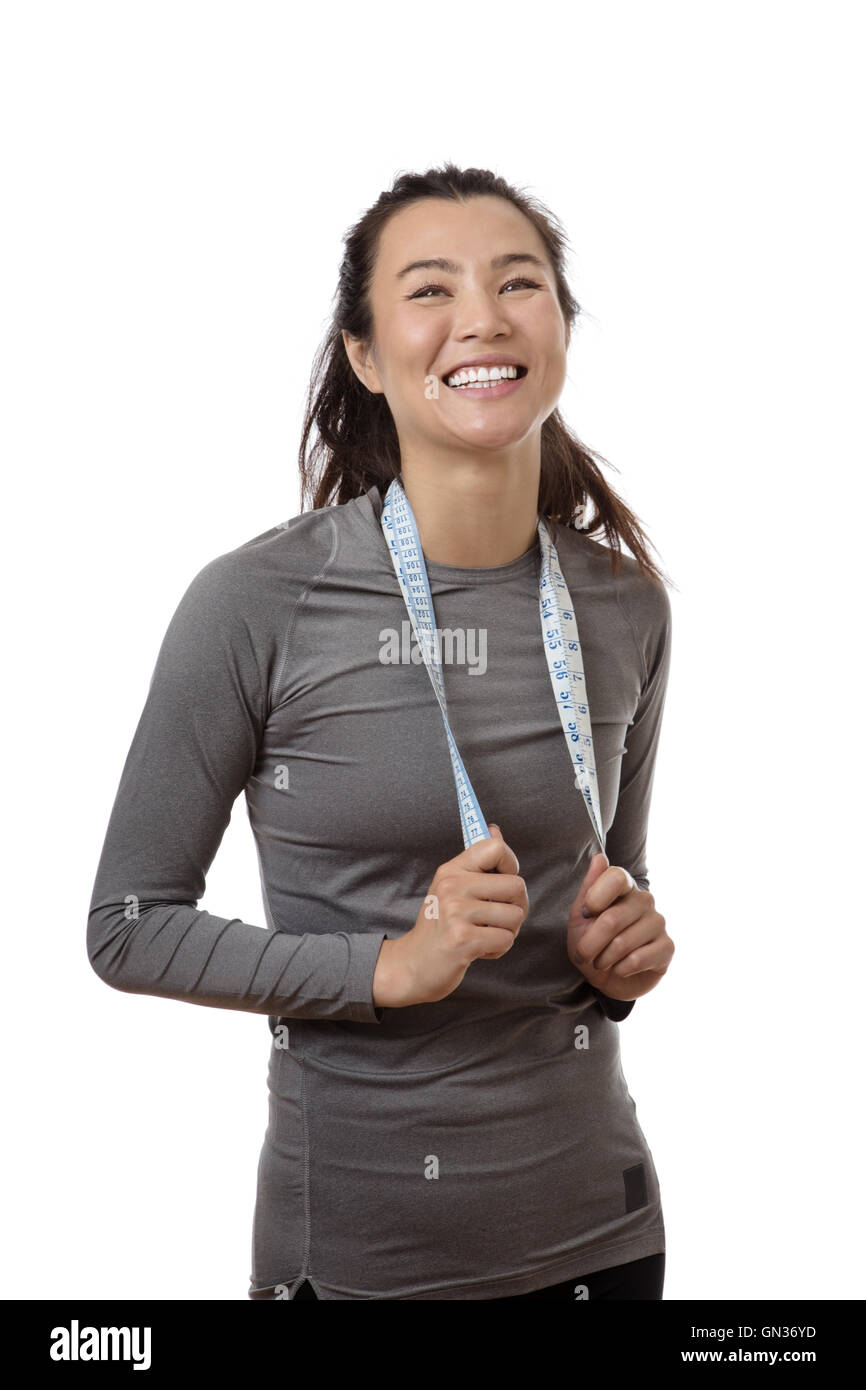 female fitness model with a tape measure around her neck Stock Photo ...