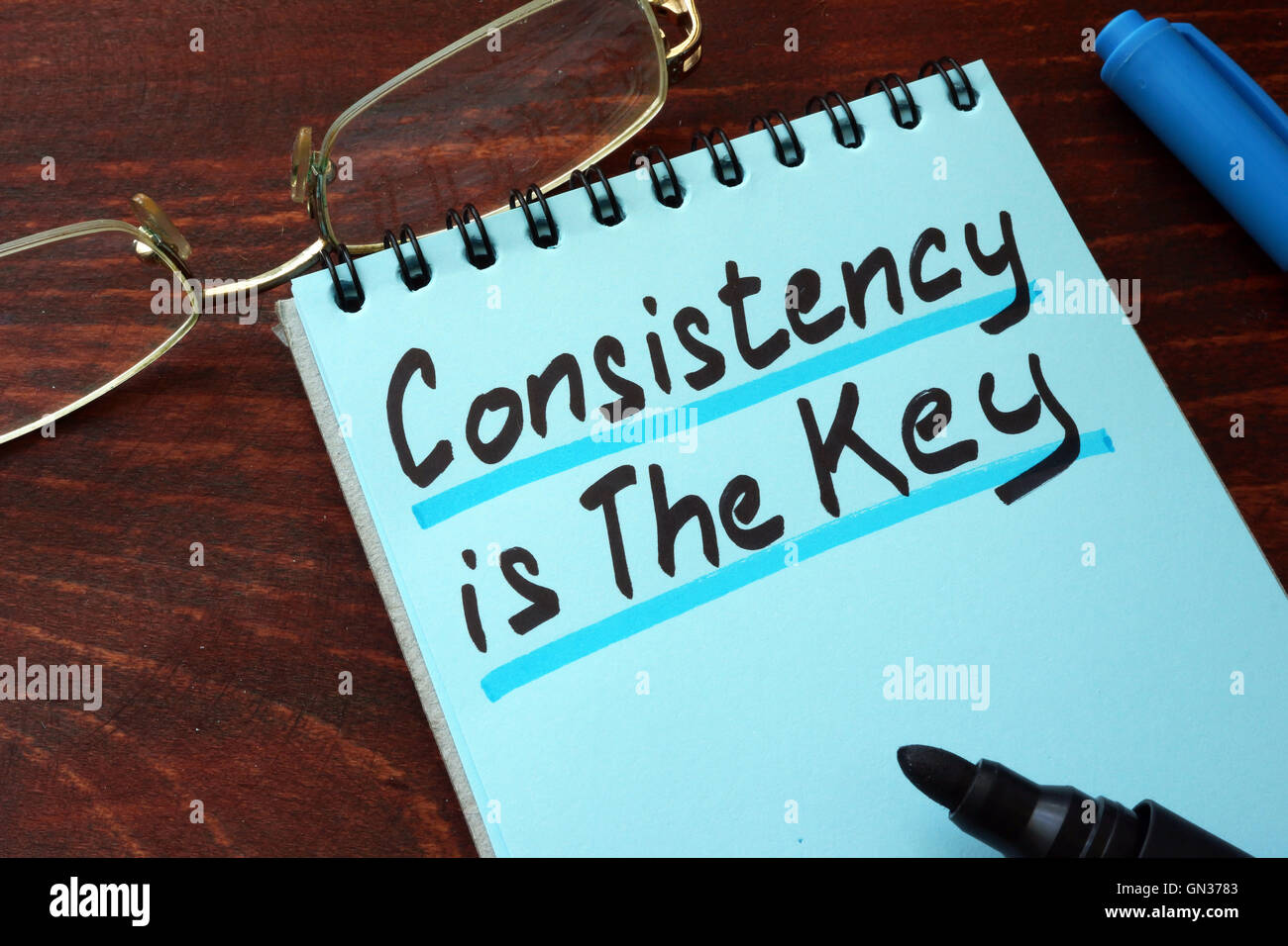 Consistency is The Key written on a notepad with marker Stock Photo - Alamy