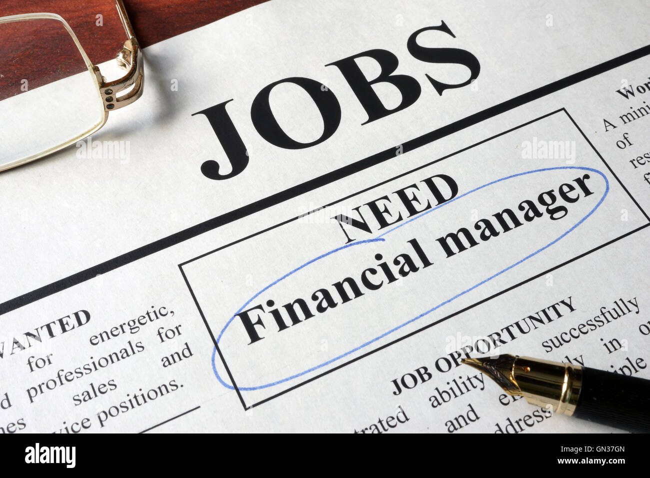 Newspaper with ads for vacancy financial manager. Employment concept ...