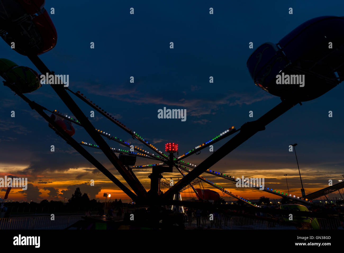 Amusement ride pictured at dusk against a pretty sunset sky Stock Photo ...