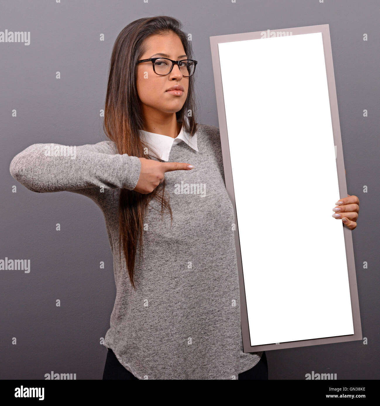 Portrait of smiling woman holding blank sign board.Studio portrait of ...