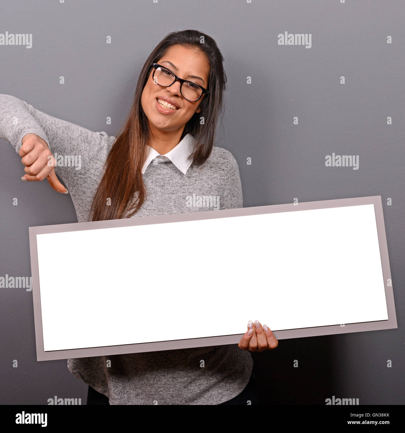 Portrait of smiling woman holding blank sign board.Studio portrait of ...