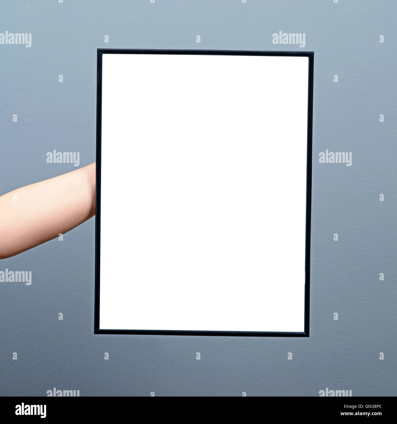 Hand holding blank board against gray background Stock Photo - Alamy