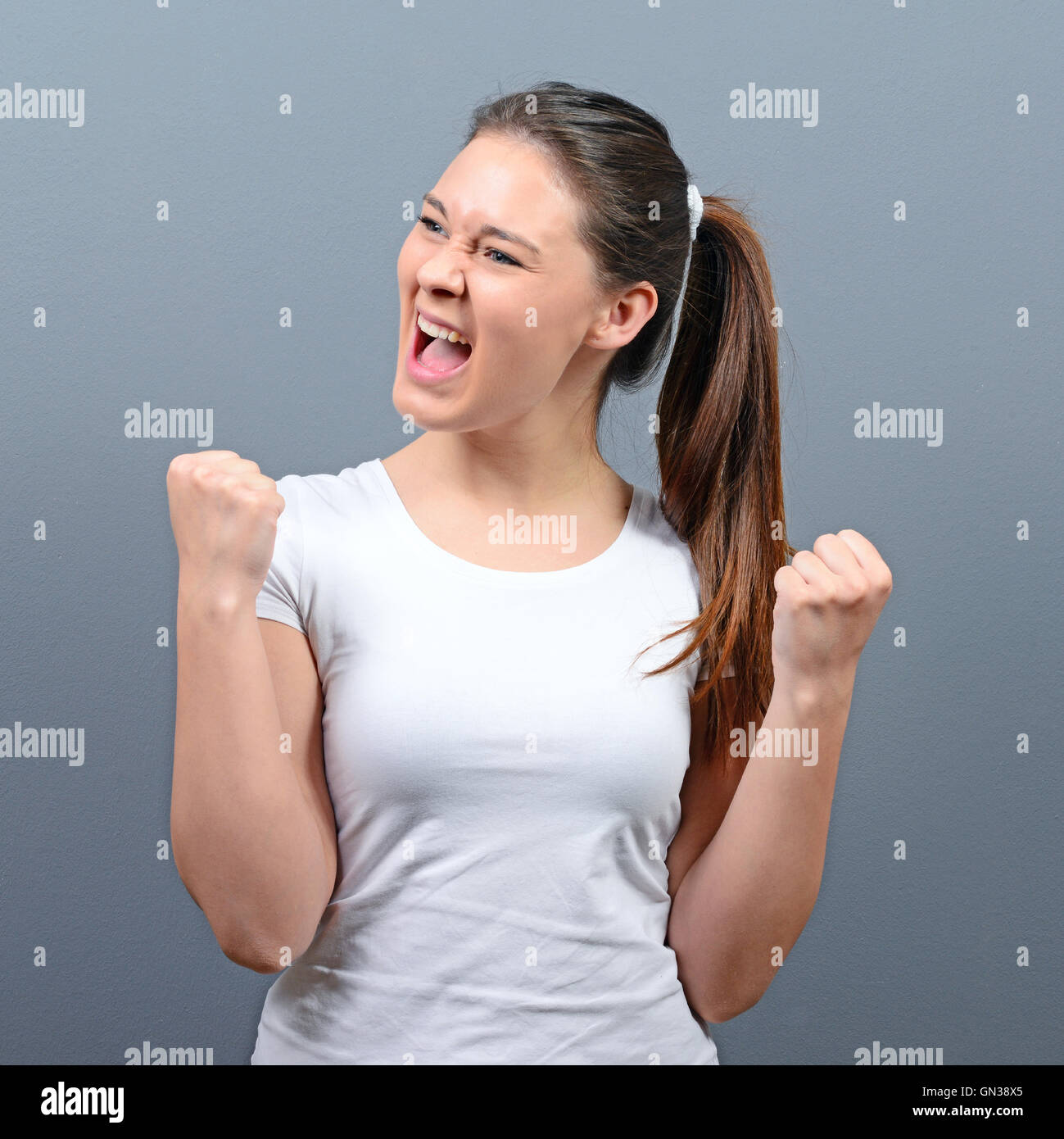 Portrait of happy woman exults pumping fists ecstatic celebrates ...