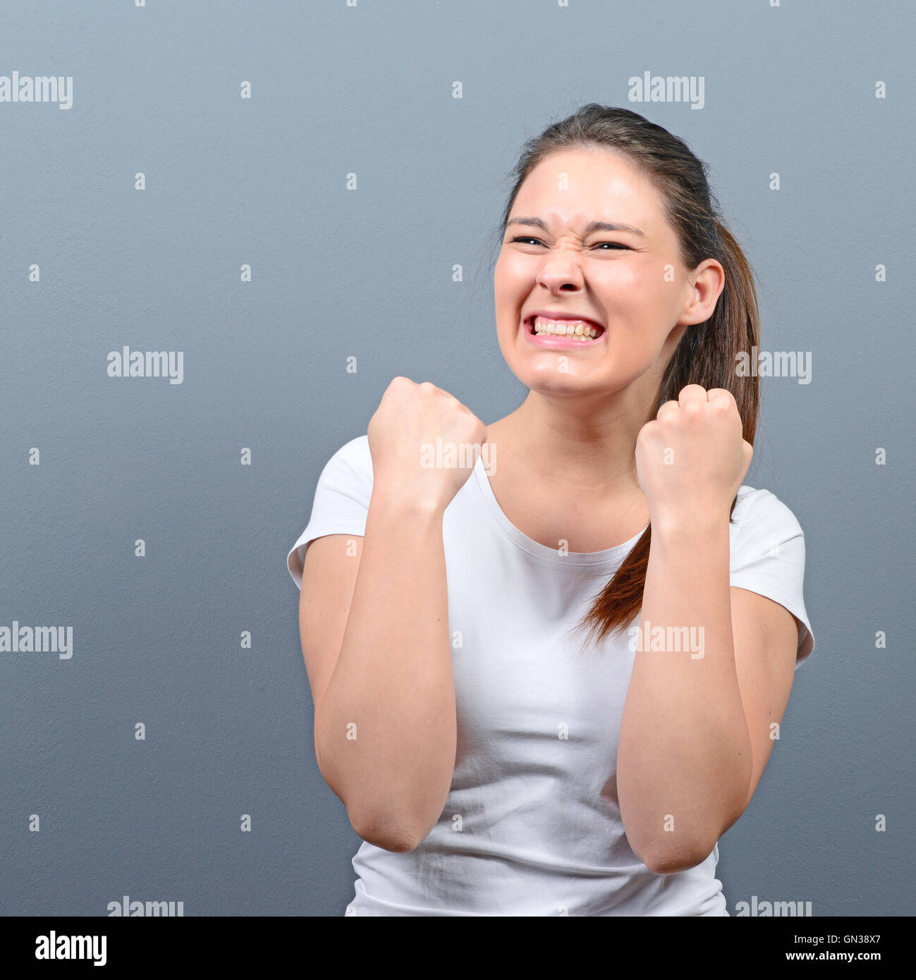 Portrait of happy woman exults pumping fists ecstatic celebrates ...