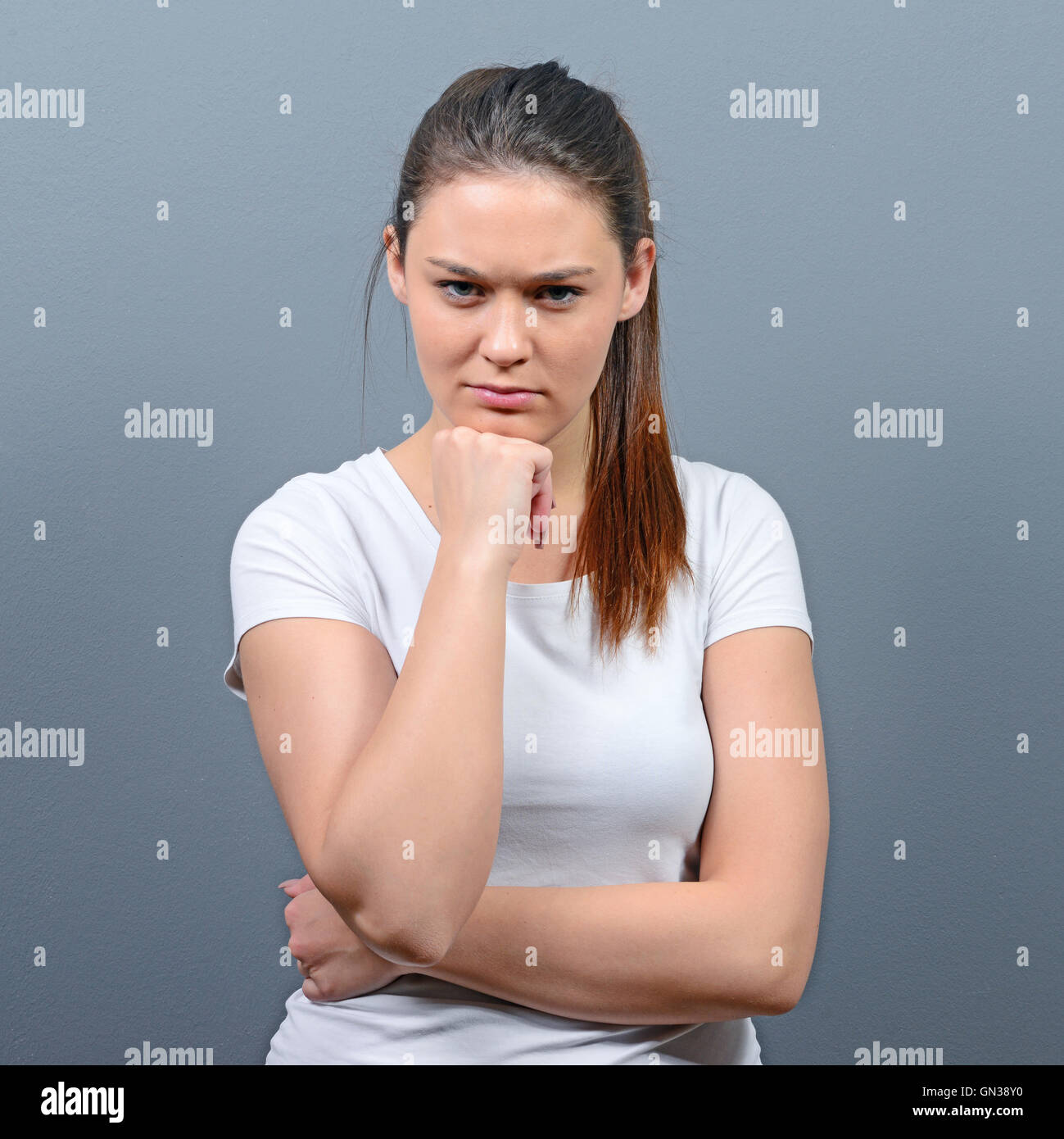 Portrait of mad woman against gray background Stock Photo - Alamy