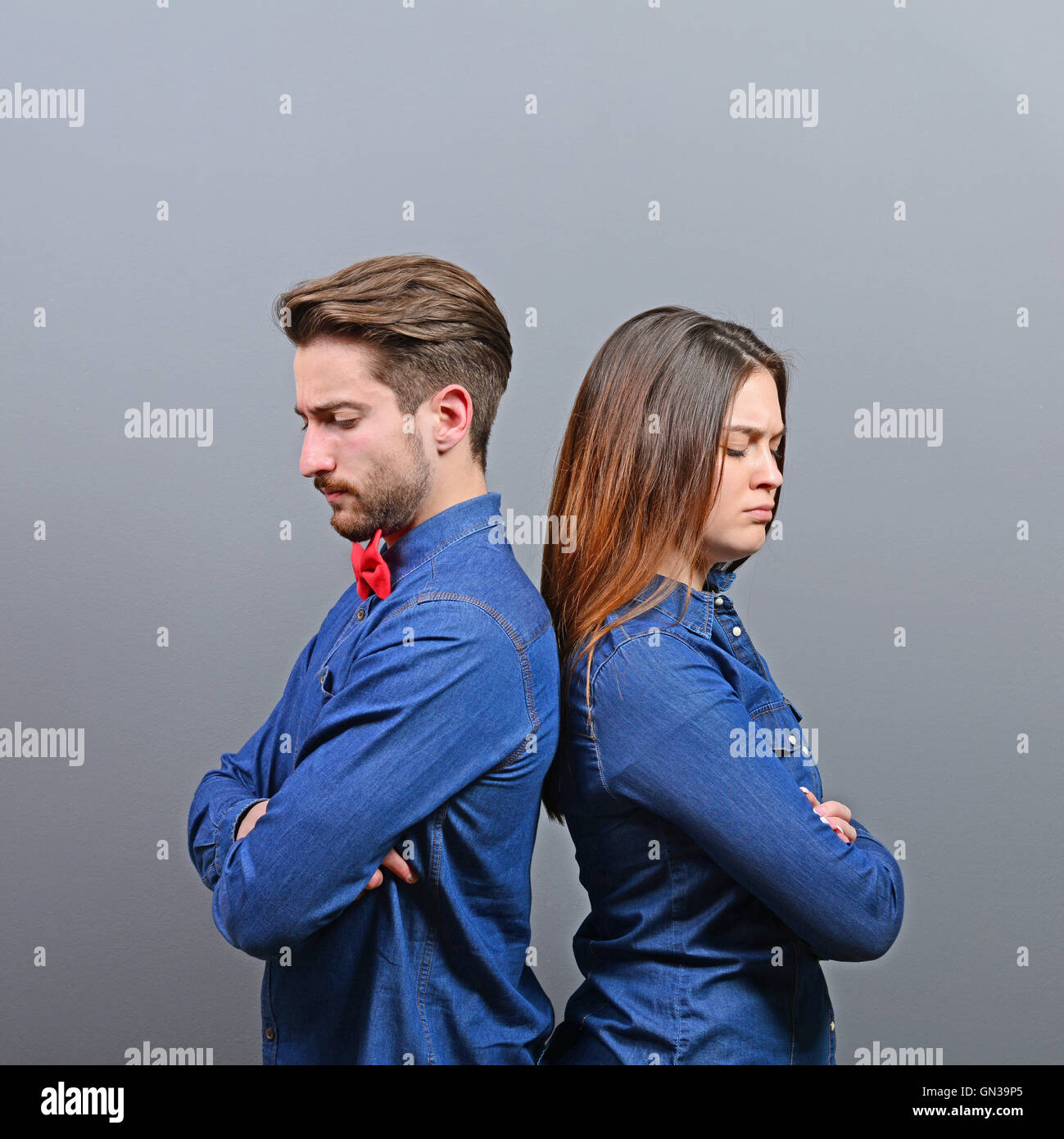 Angry couple turning their back on each other Stock Photo - Alamy