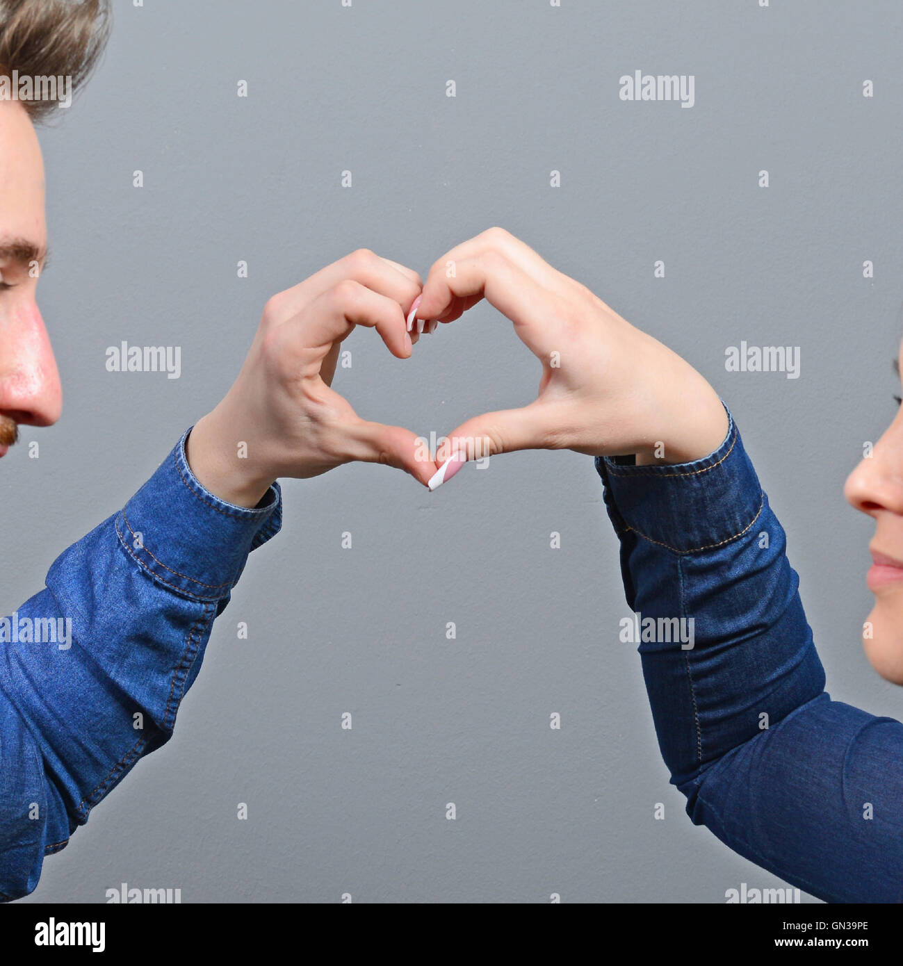 Couple making heart shape with hands Stock Photo - Alamy