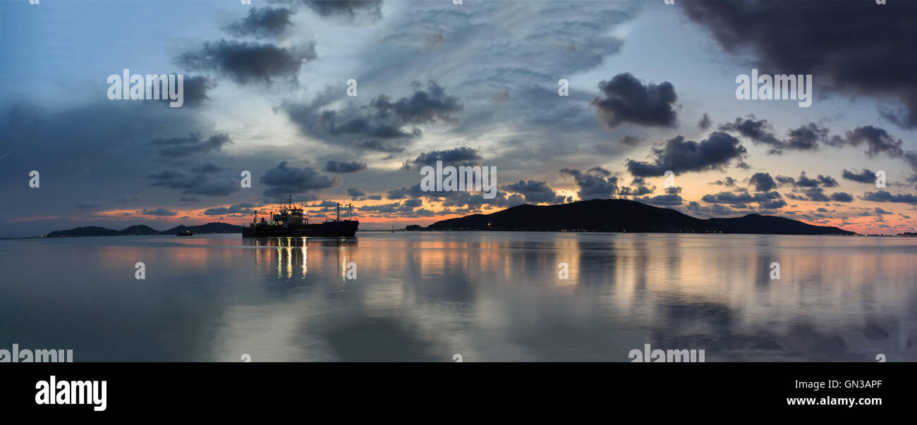 Fishing boat sunset panoramic reflection Stock Photo - Alamy