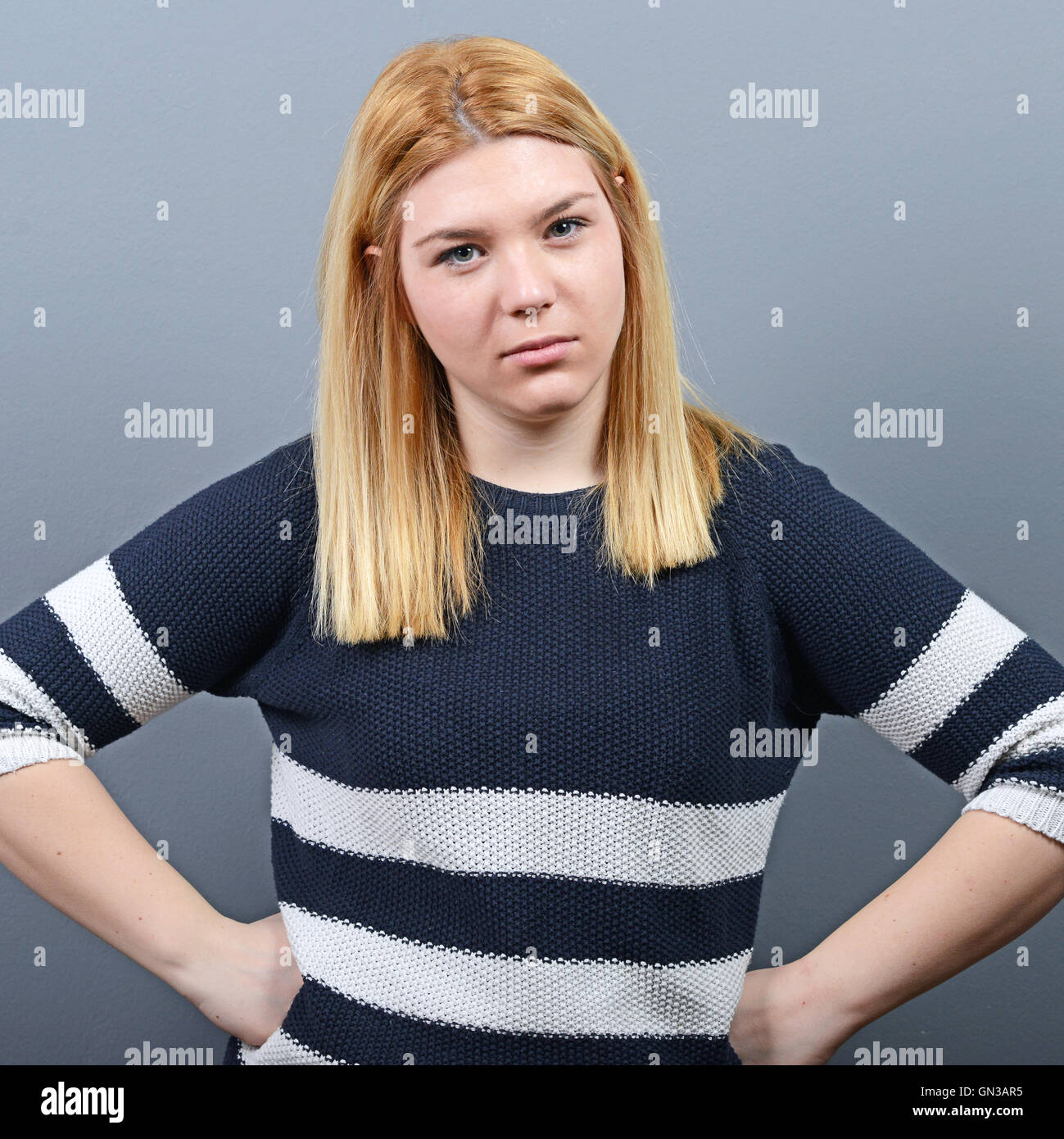 Portrait of mad woman against gray background Stock Photo - Alamy