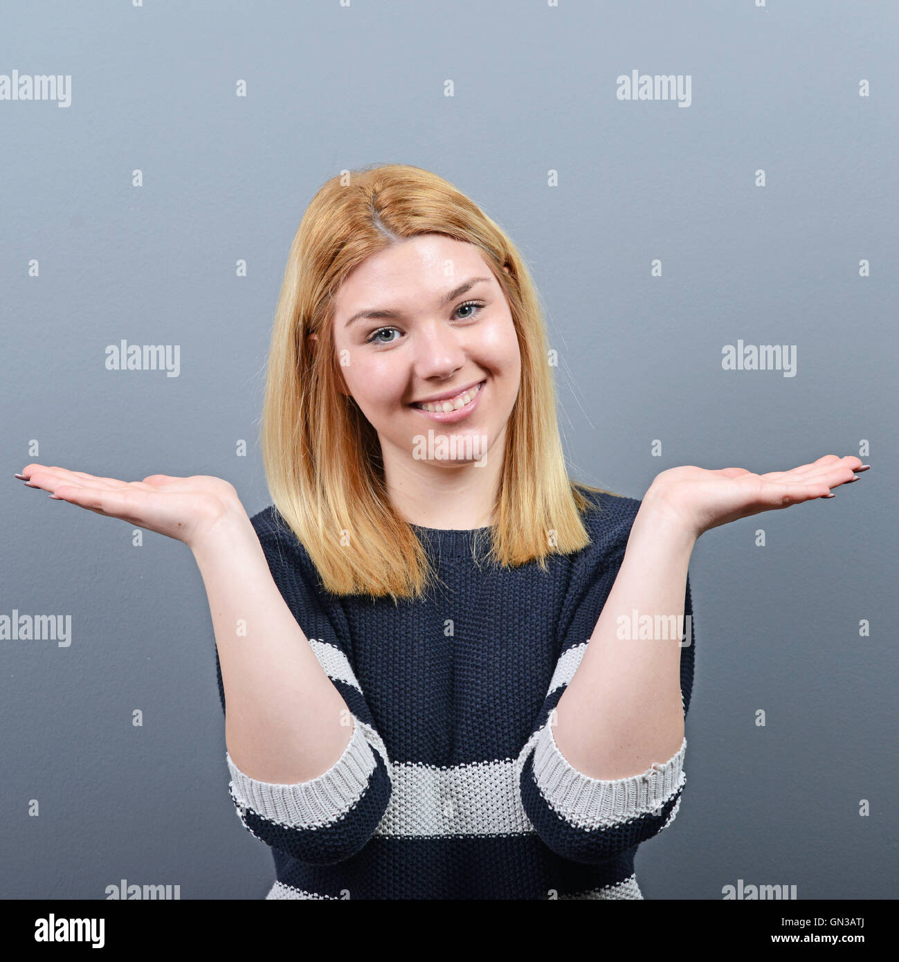 Portrait of woman balancing something on both palms of her hands for ...
