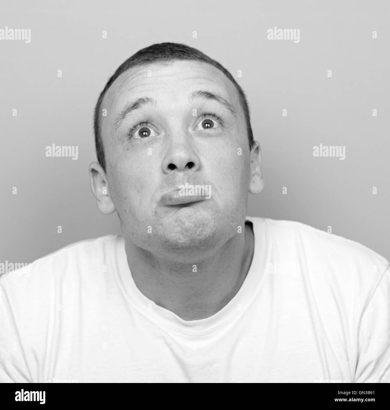 Portrait of desperate man against green background Stock Photo - Alamy