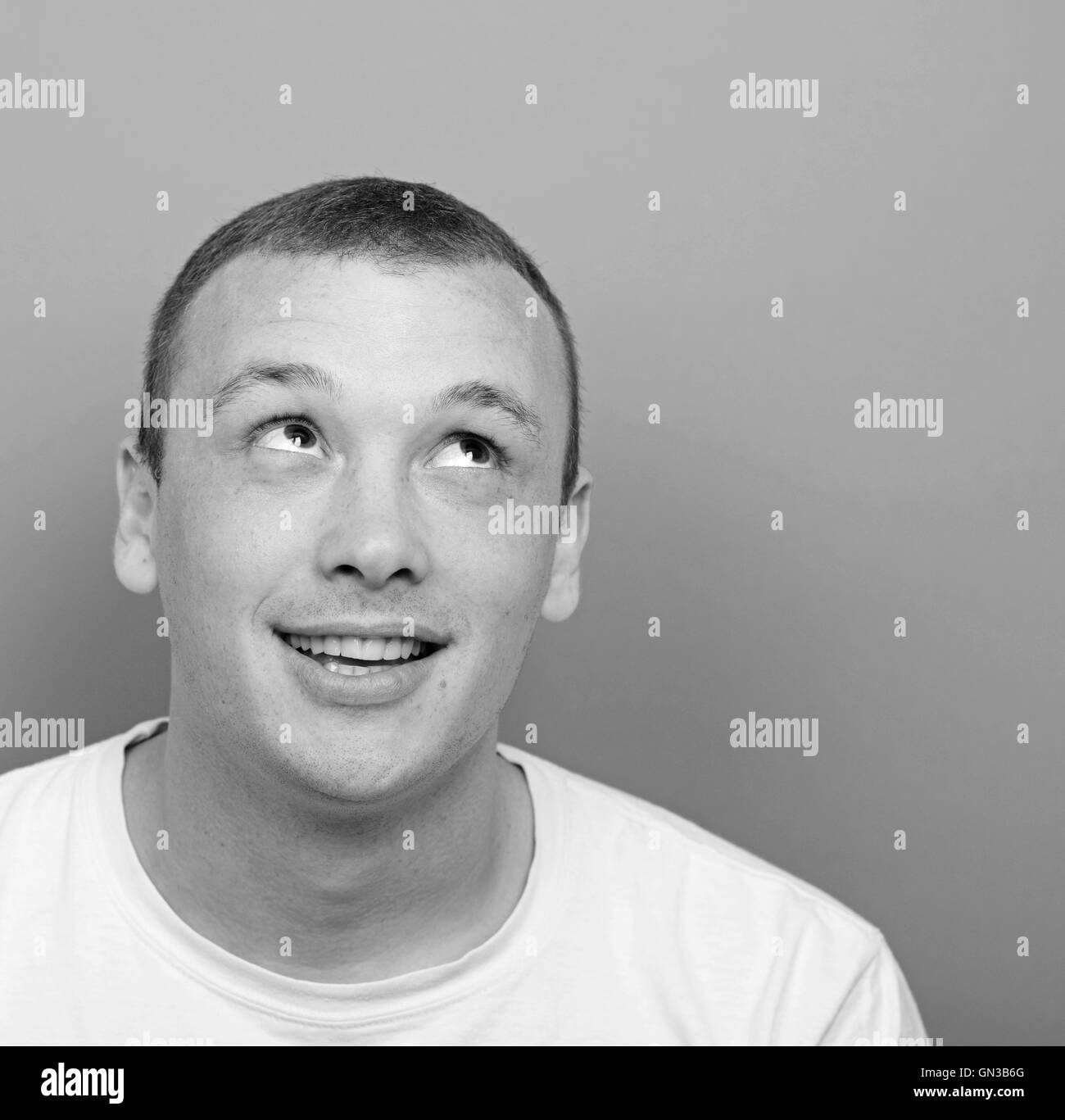 Portrait of happy young man looking up Stock Photo - Alamy