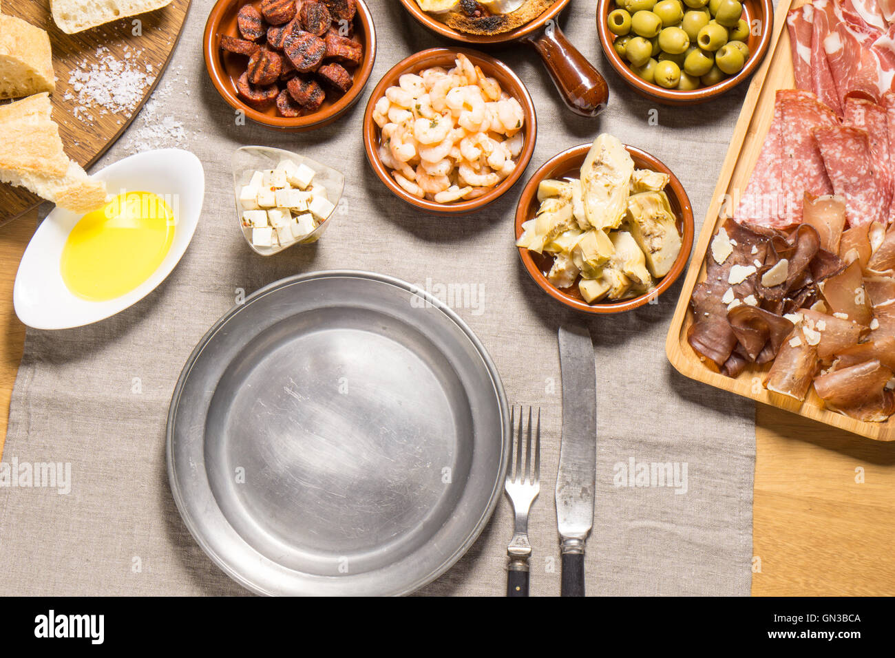 Tapas food, served in small bowls cold meat, goat cheese. A meal for ...