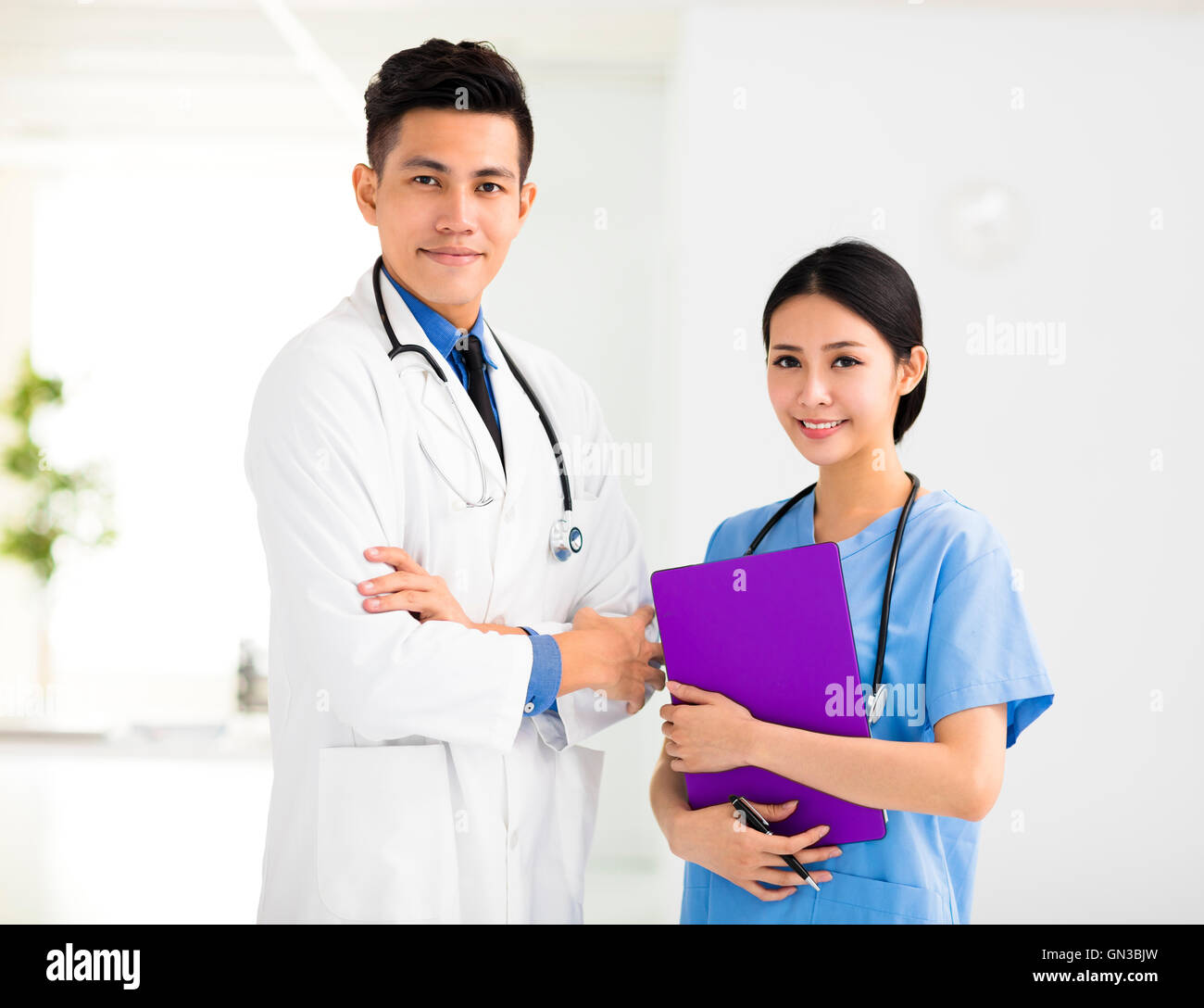 smiling Medical doctors working in the office Stock Photo - Alamy