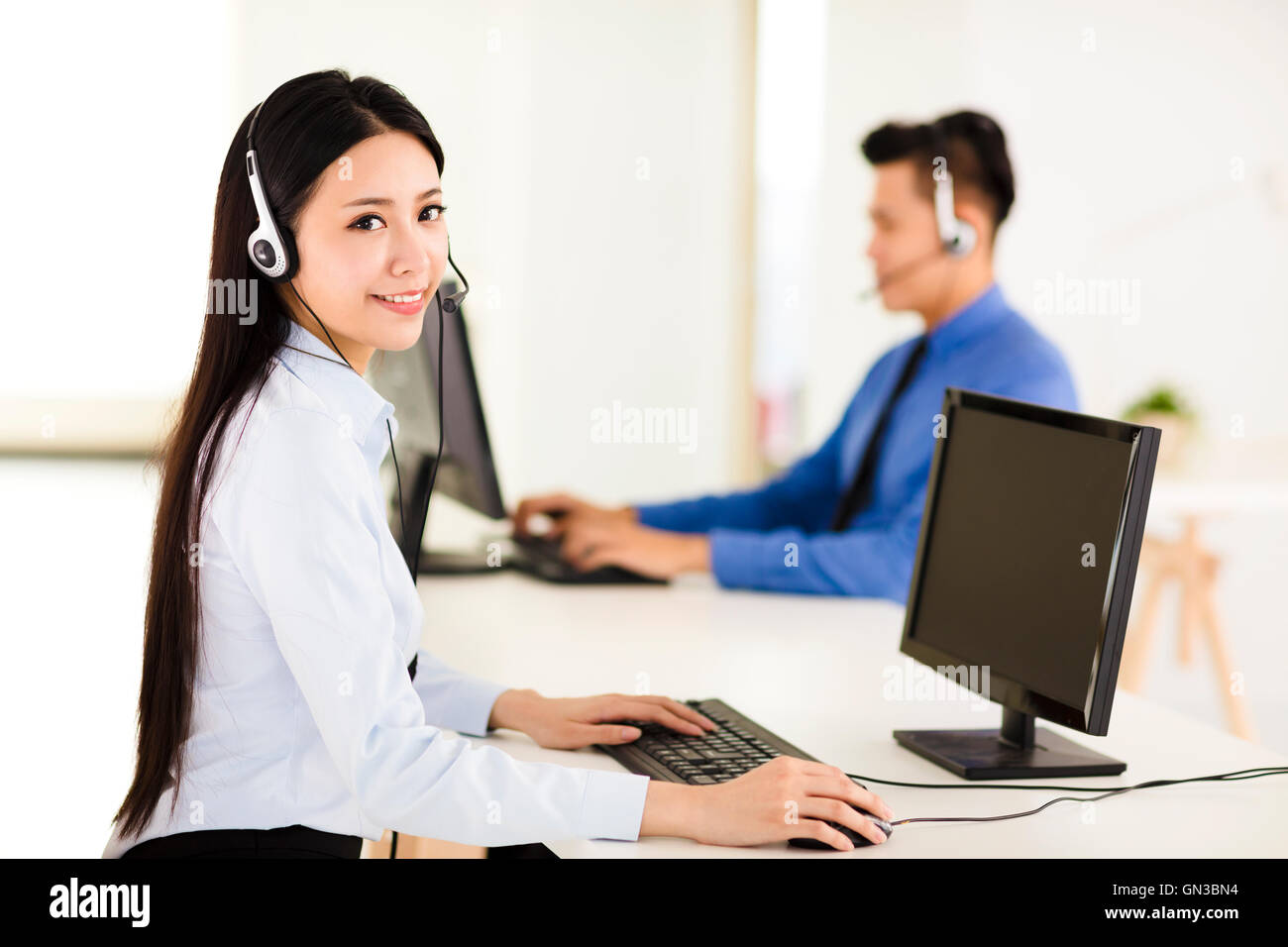 Beautiful call center agent working in office Stock Photo - Alamy