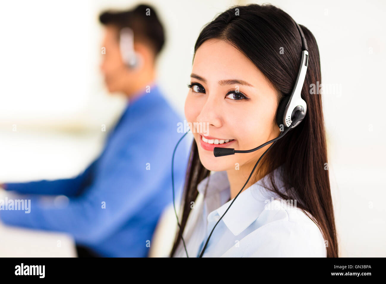 Beautiful call center agent working in office Stock Photo - Alamy