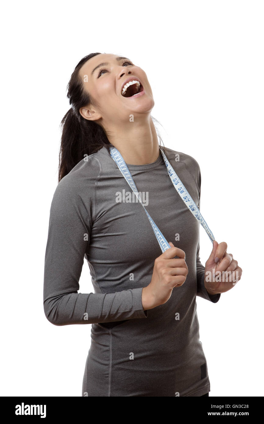 female fitness model with a tape measure around her neck Stock Photo ...