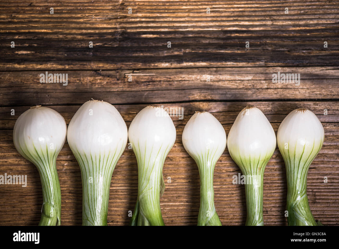 green onion on wooden border background Stock Photo - Alamy