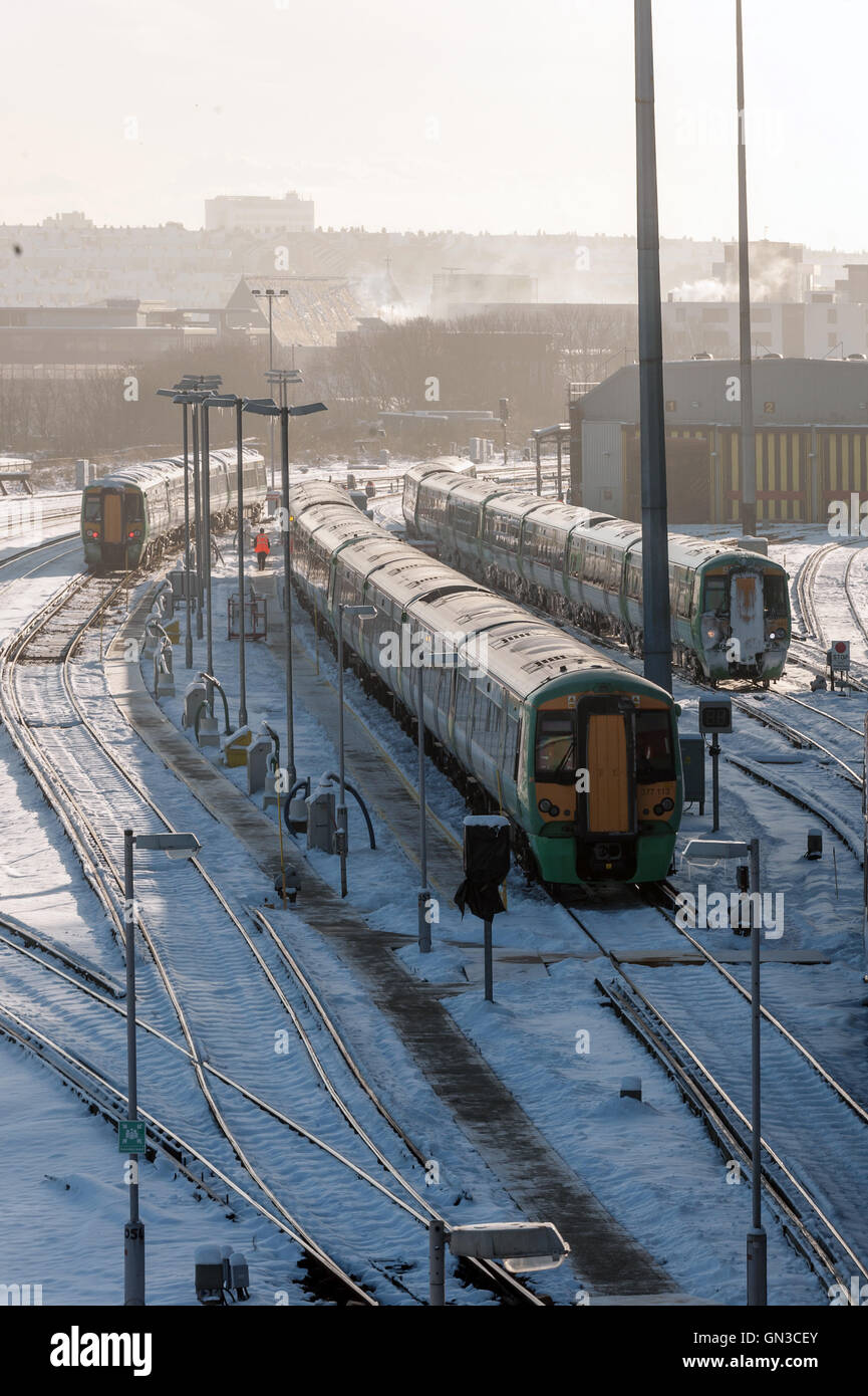 Railway trains travel through the snow on a winter's morning in ...