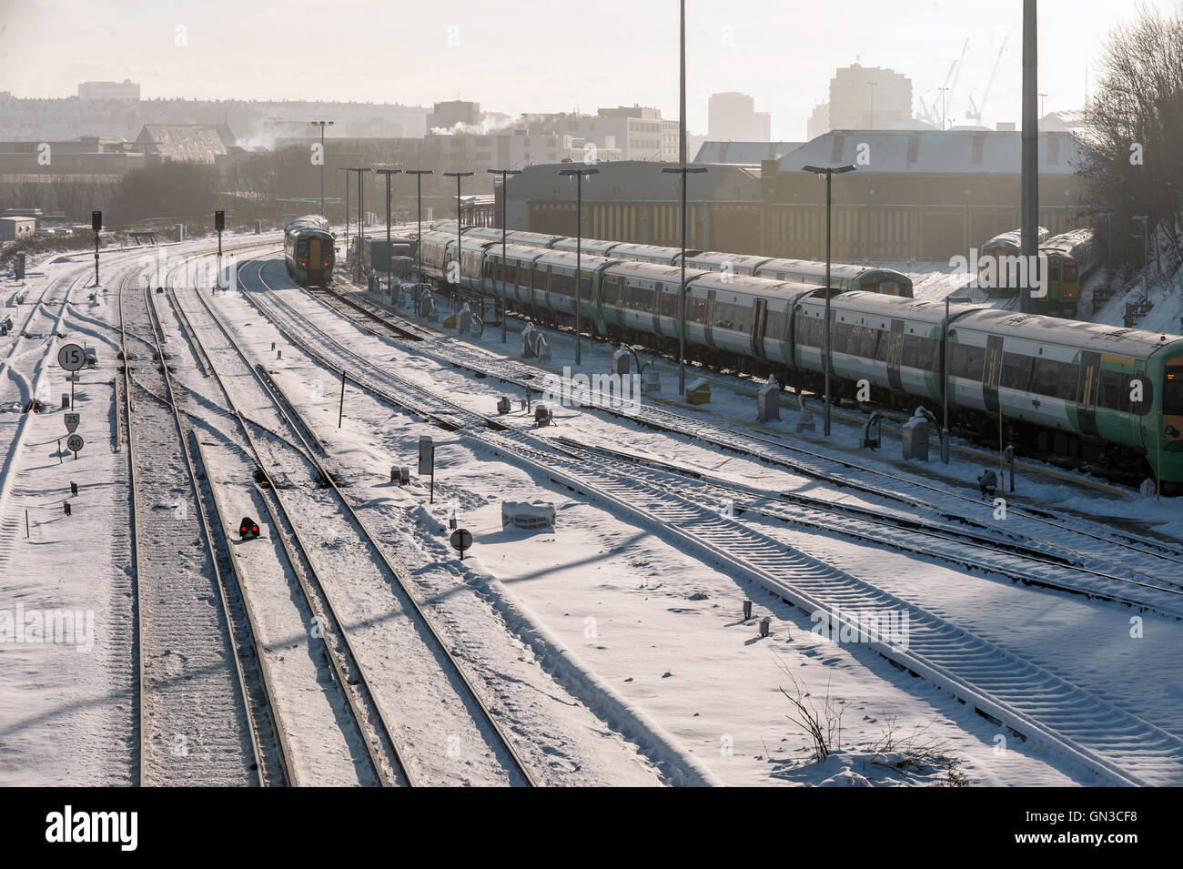 Railway trains travel through the snow on a winter's morning in ...