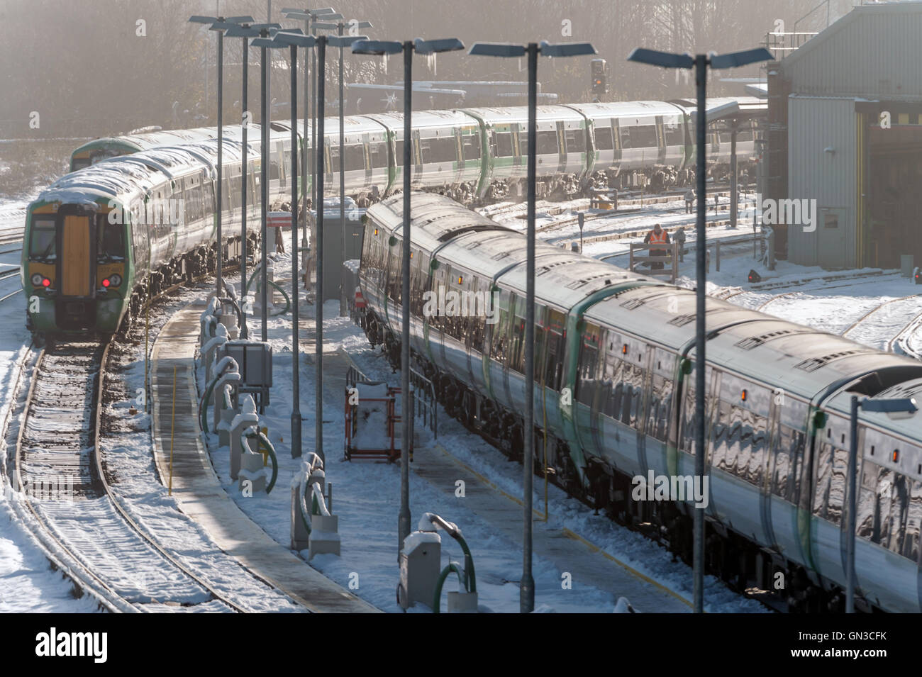 Railway trains travel through the snow on a winter's morning in ...