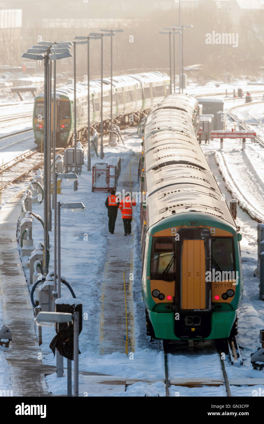 Railway trains travel through the snow on a winter's morning in ...