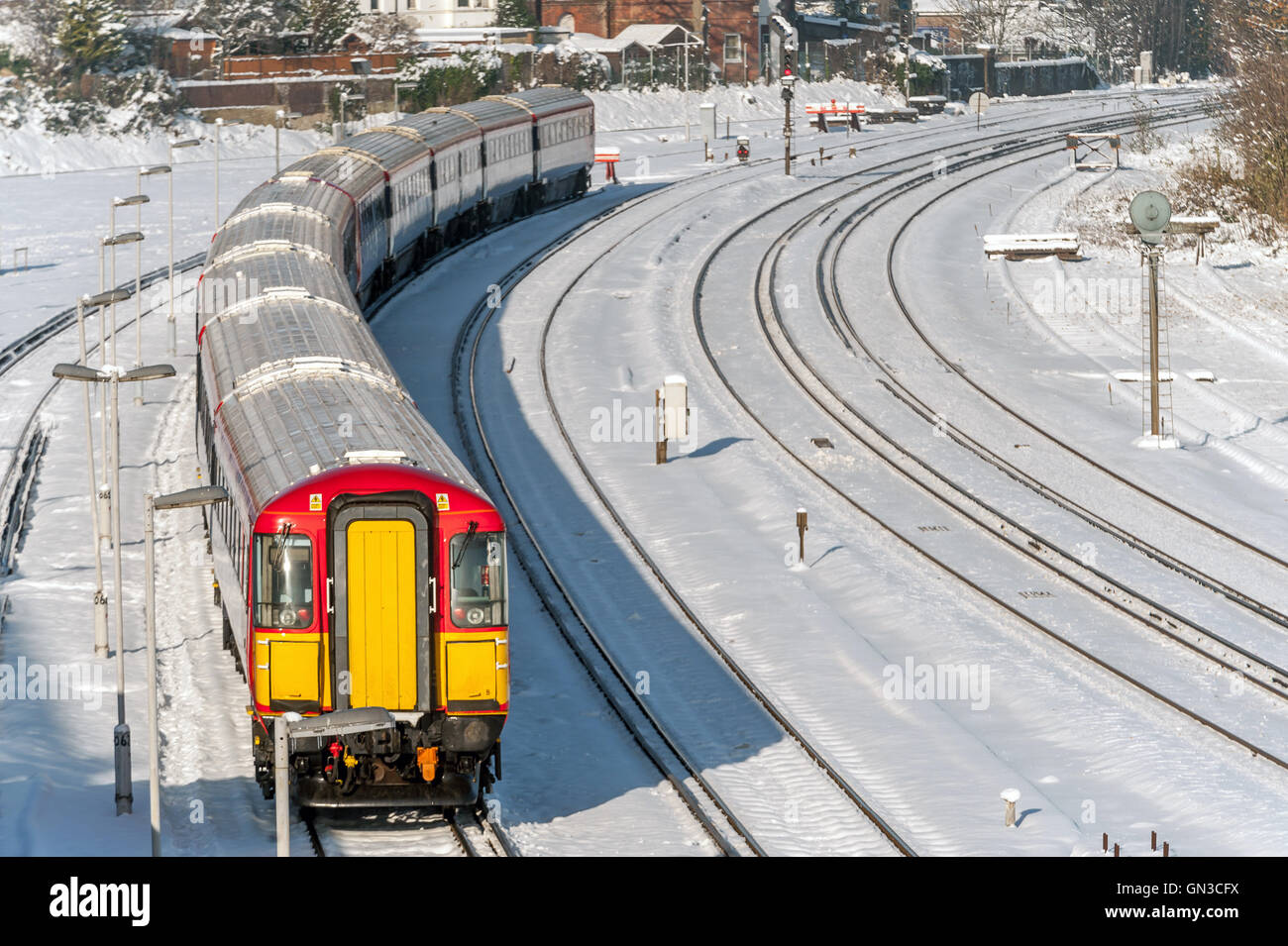 Railway trains travel through the snow on a winter's morning in ...