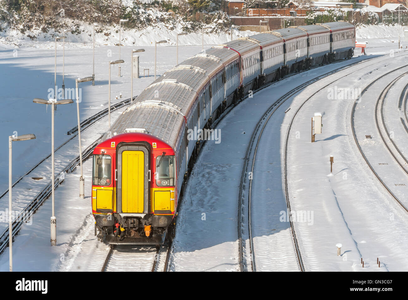 Railway trains travel through the snow on a winter's morning in ...
