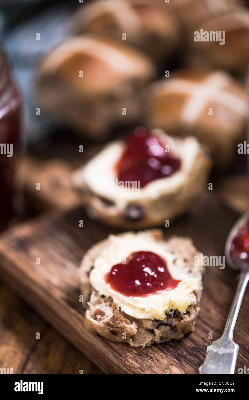 english hot cross bun with clotted cream and jam Stock Photo - Alamy