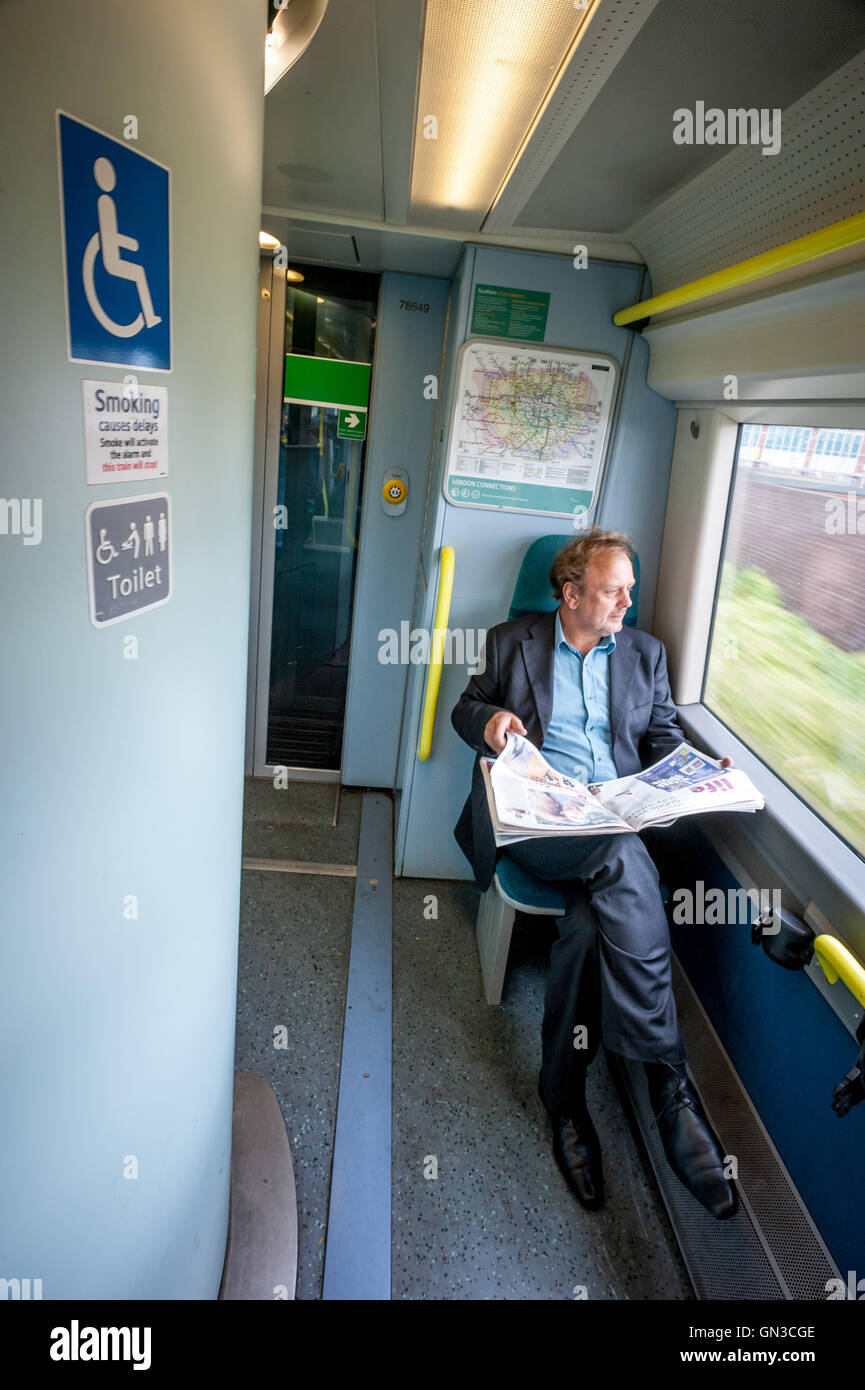 A passenger using the onboard toilet facilities on a train Stock Photo ...