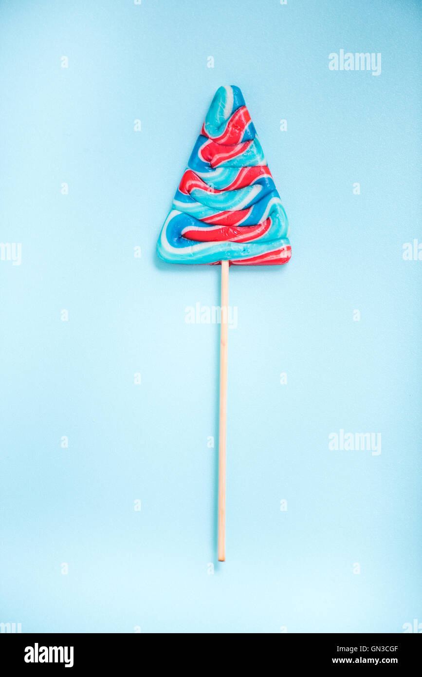 blue and red lollipop candy on blue background Stock Photo - Alamy