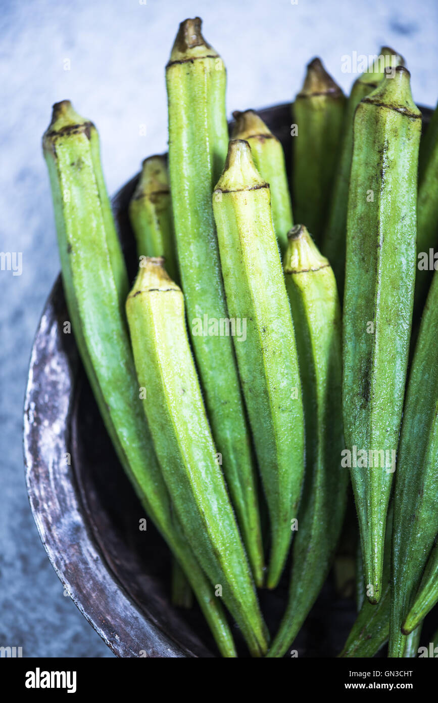 Okra whole vegetable in rustic bowl Stock Photo - Alamy