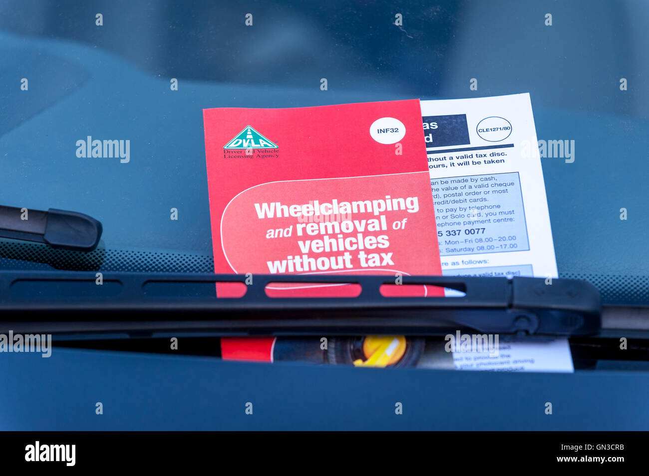 An untaxed vehicle is clamped ready for removal on the streets of ...