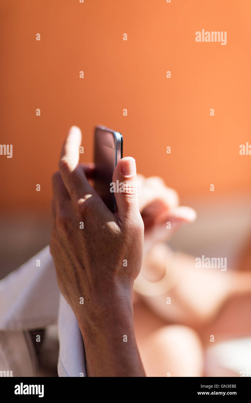 mobile phone held by mature woman hand Stock Photo - Alamy