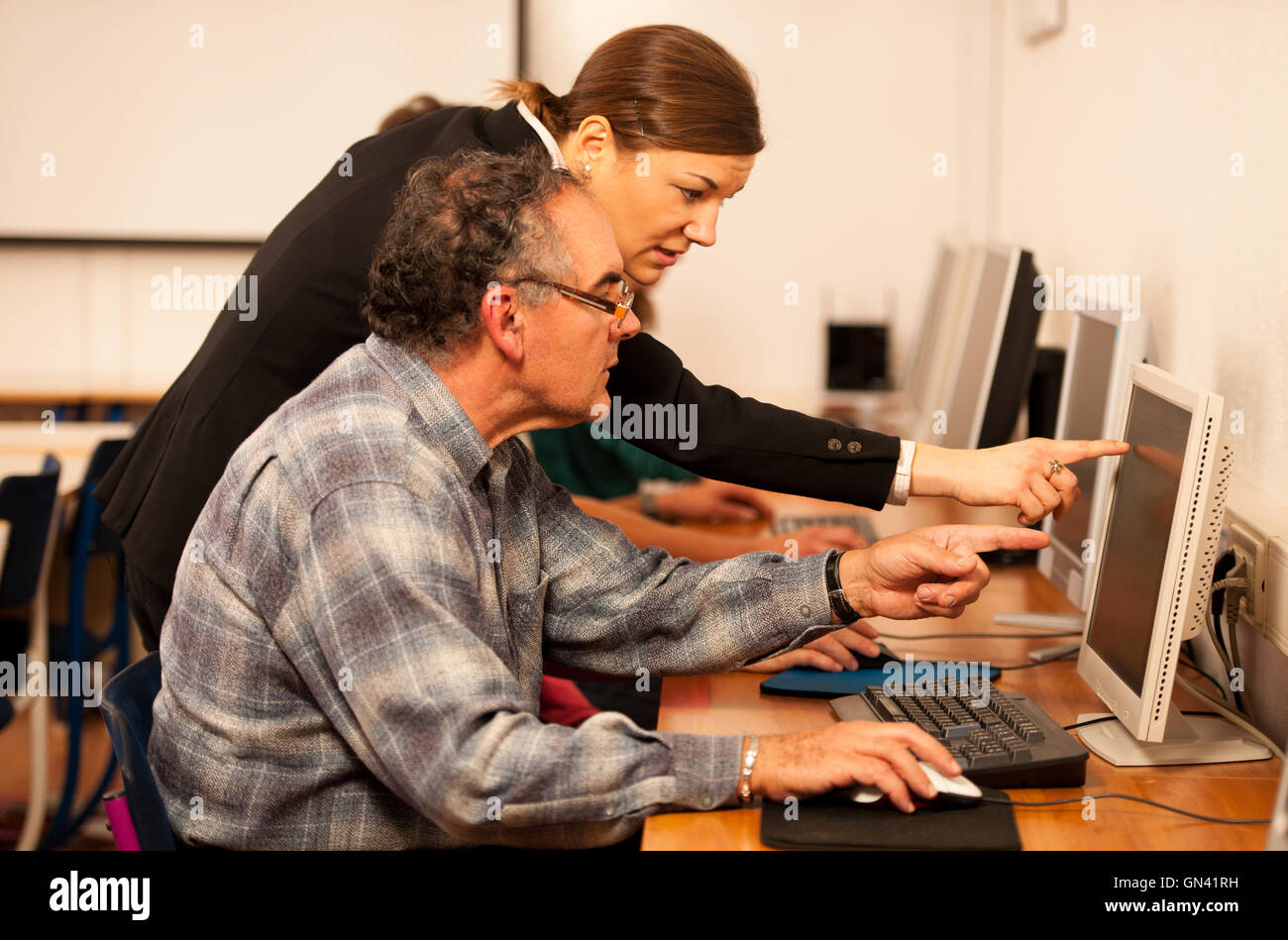 Group of adults learning computer skills. Intergenerational transfer of ...