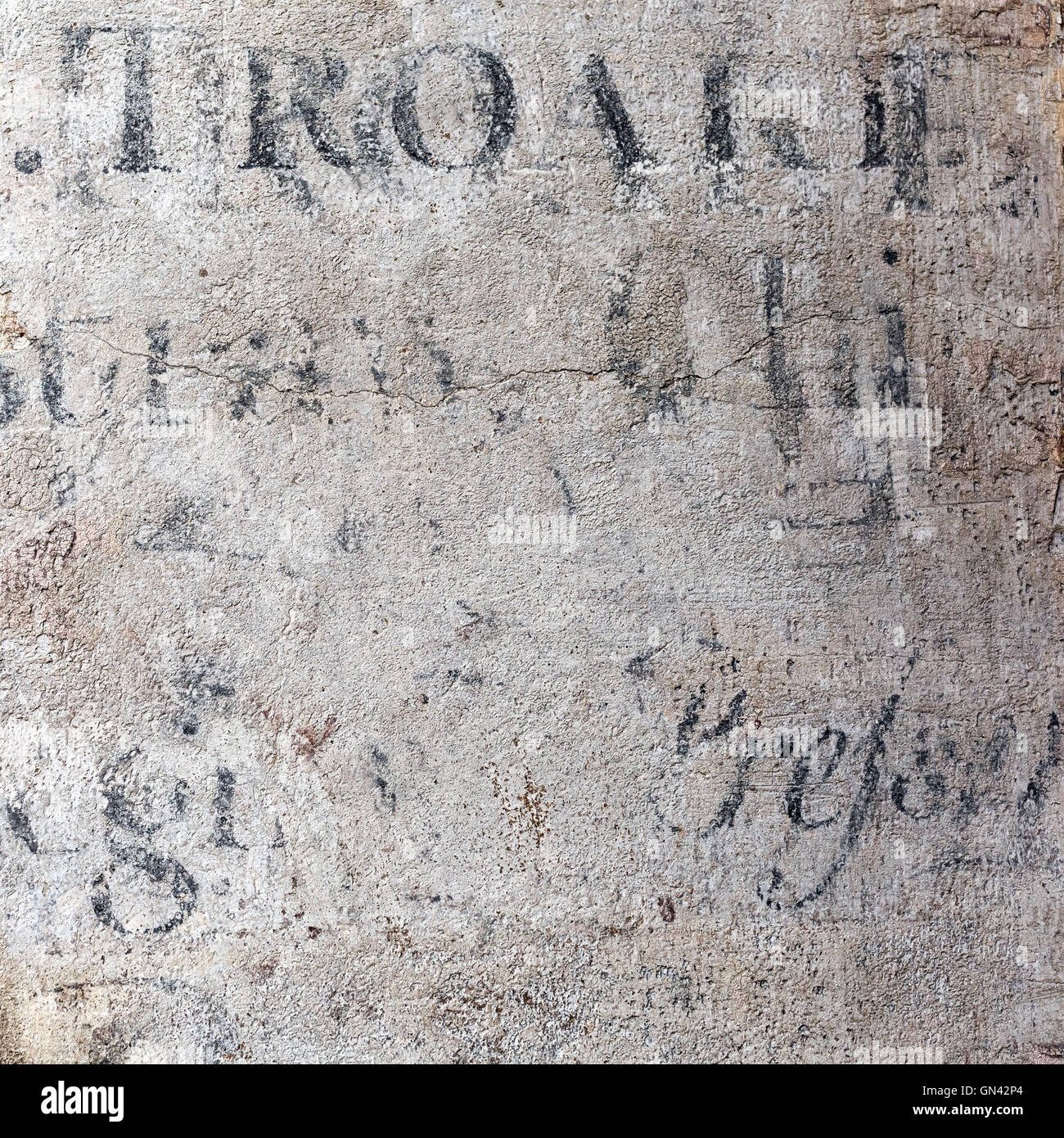 antique background texture from fragmented letters on a weathered wall ...