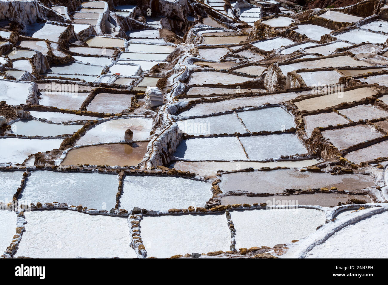 Salt ponds in Maras Peru covering a hillside with rich minerals and a ...