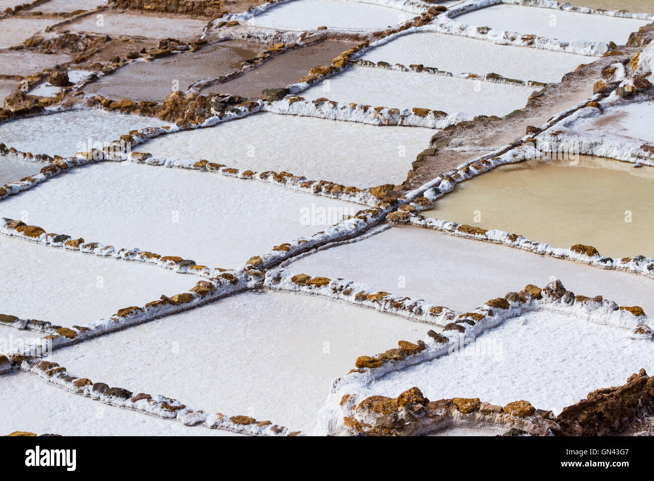 Salt ponds in Maras Peru covering a hillside with rich minerals and a ...