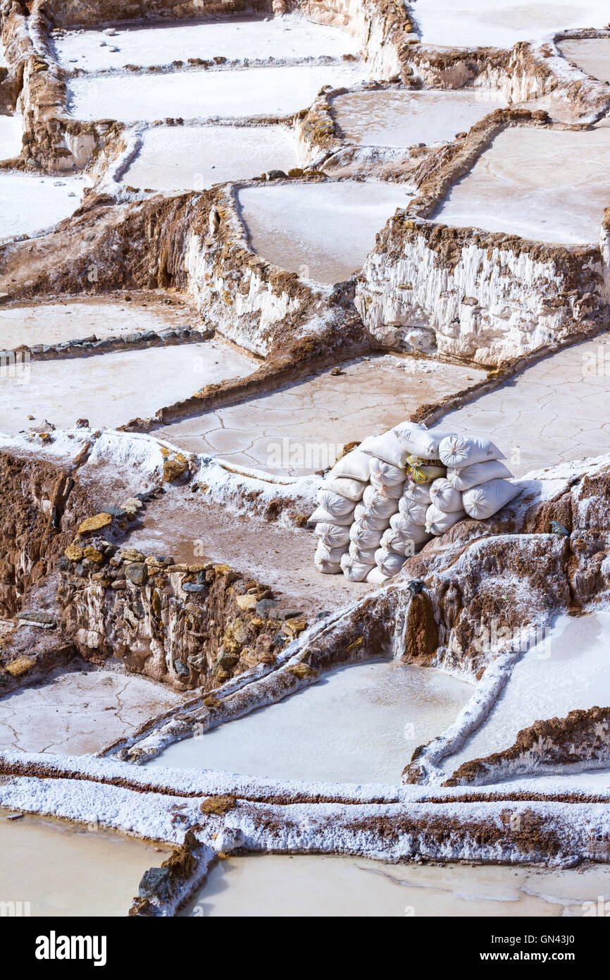 Salt ponds in Maras Peru covering a hillside with rich minerals and a ...