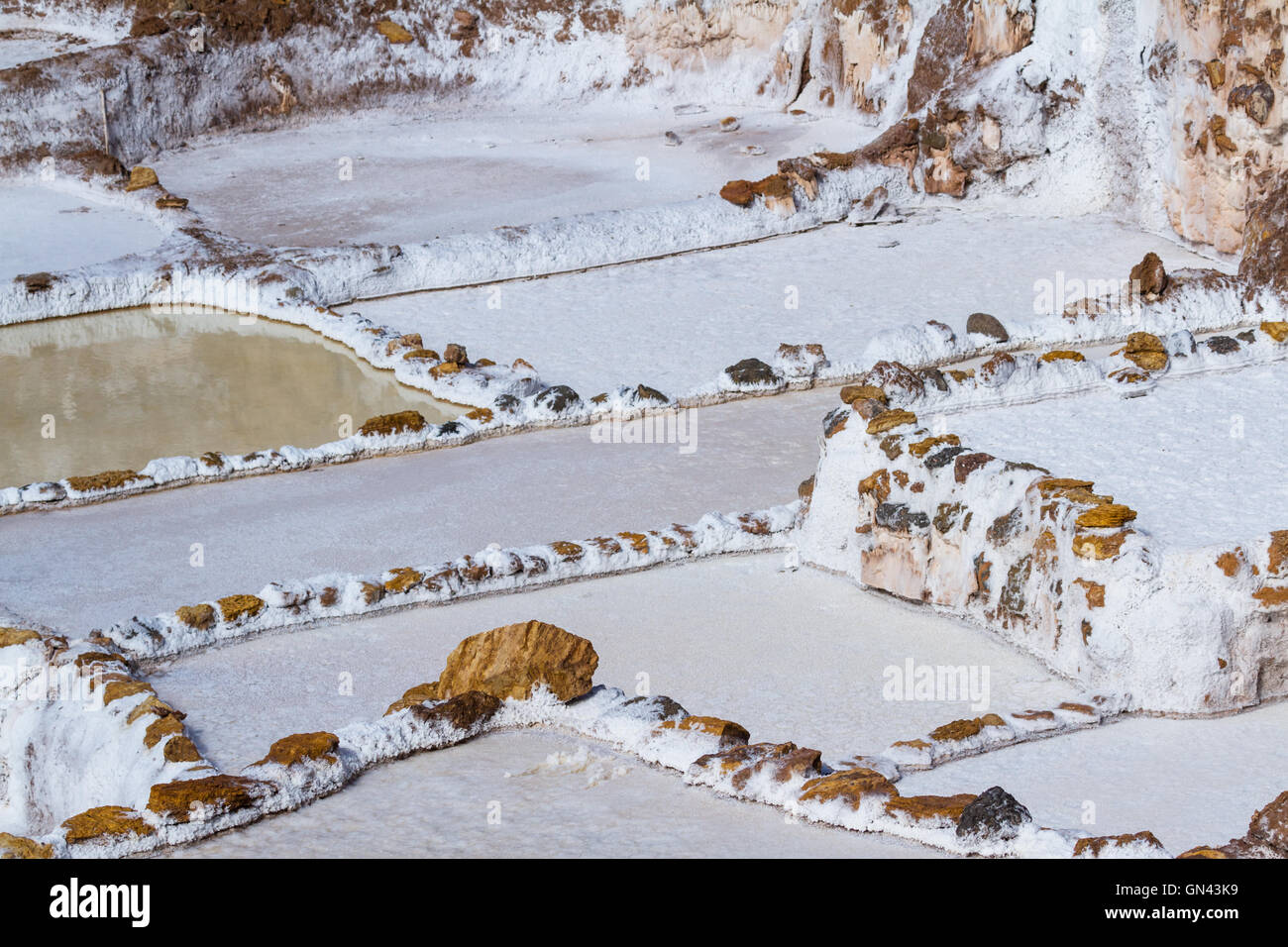 Salt ponds in Maras Peru covering a hillside with rich minerals and a ...
